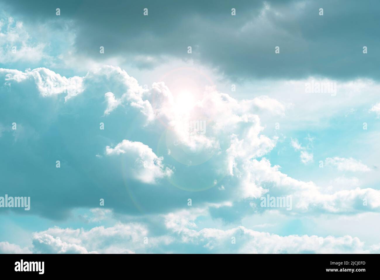 Sky.Clouds and sunshine. White clouds and sun rays in a blue sky ...