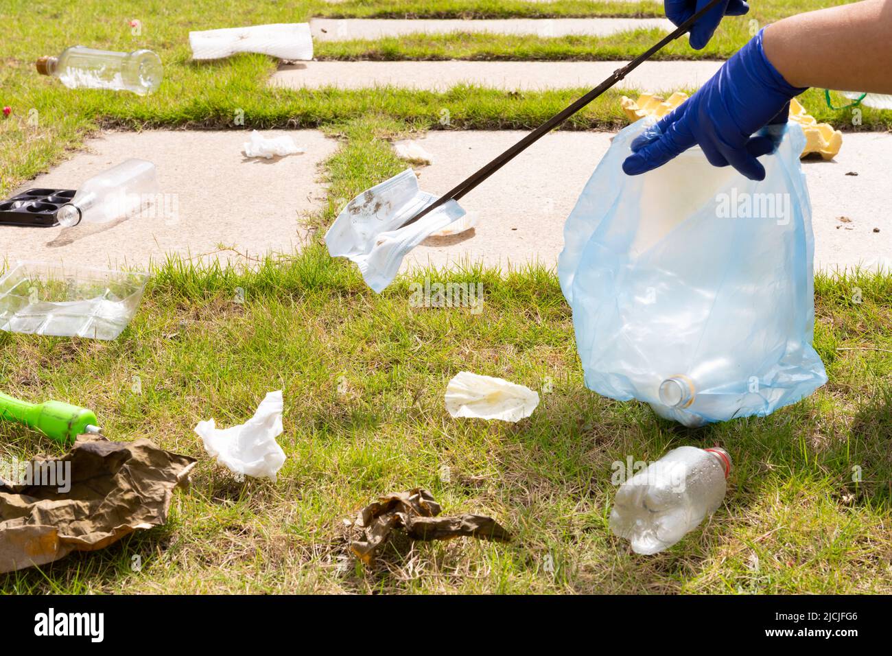 volunteer picking up rubbish in a park at horizontal composition Stock ...