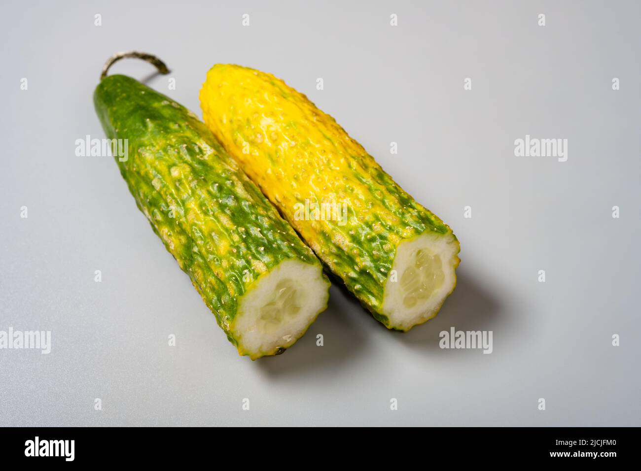 a cut out overripe cucumber on grey background Stock Photo - Alamy