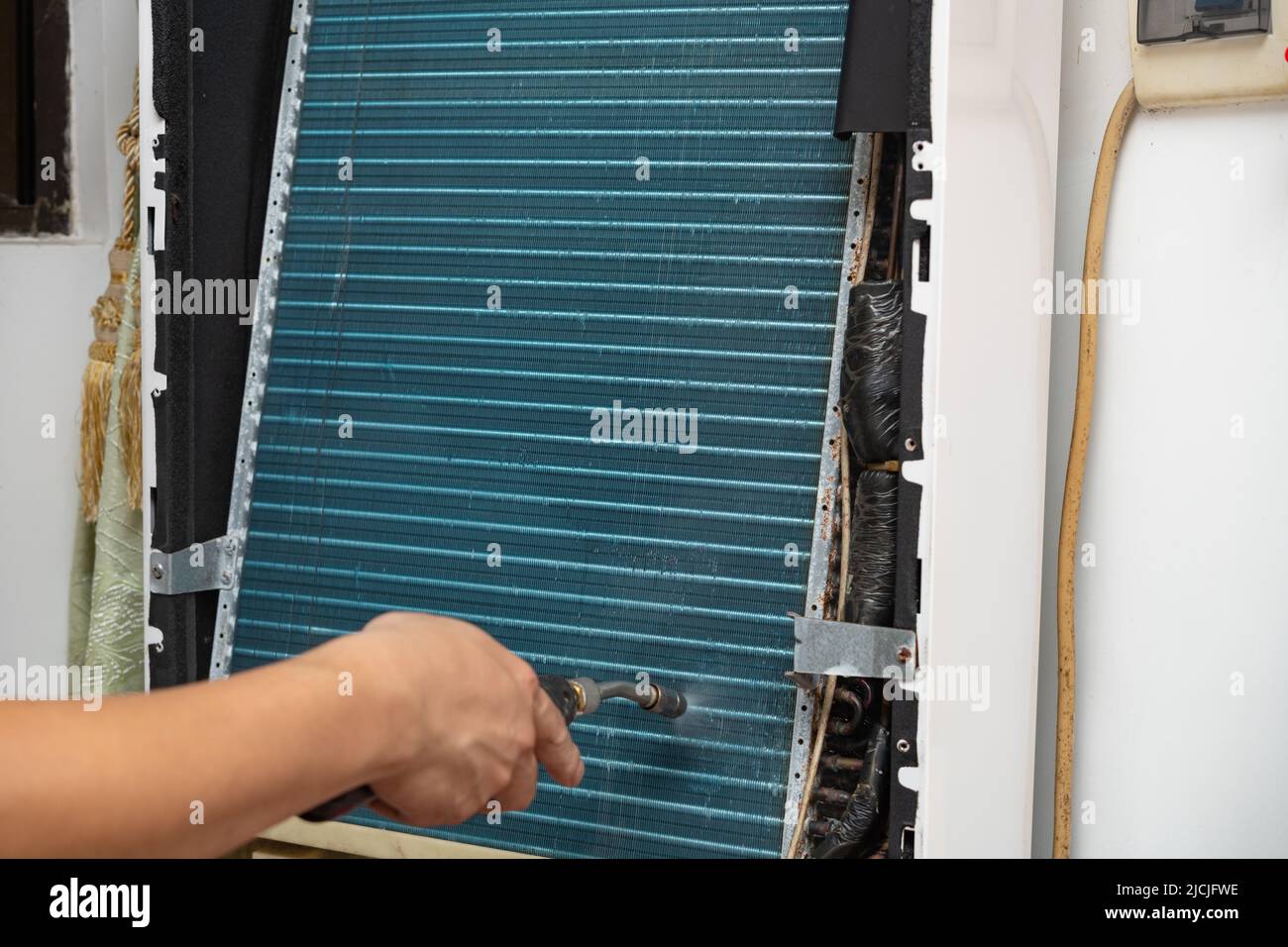 cleaning the air conditioner with chemical liquid Stock Photo - Alamy