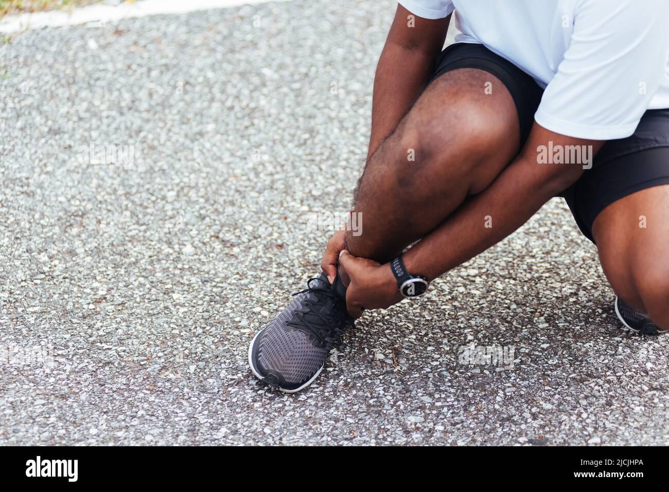 Close up Asian young sport runner black man wear watch hands joint hold ...