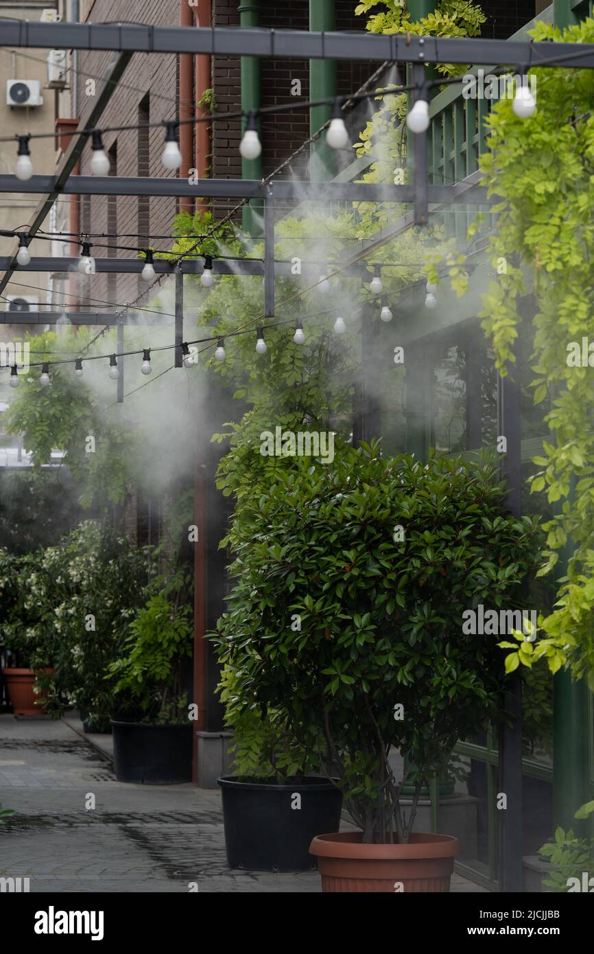 Automatic water spray system to create a cooling effect in hot weather ...