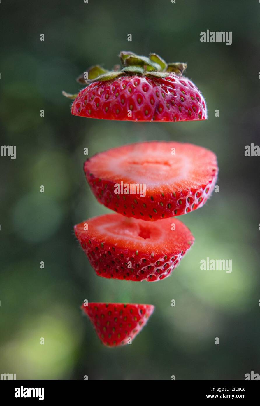 Close up of a sliced strawberry floating on a natural background Stock ...