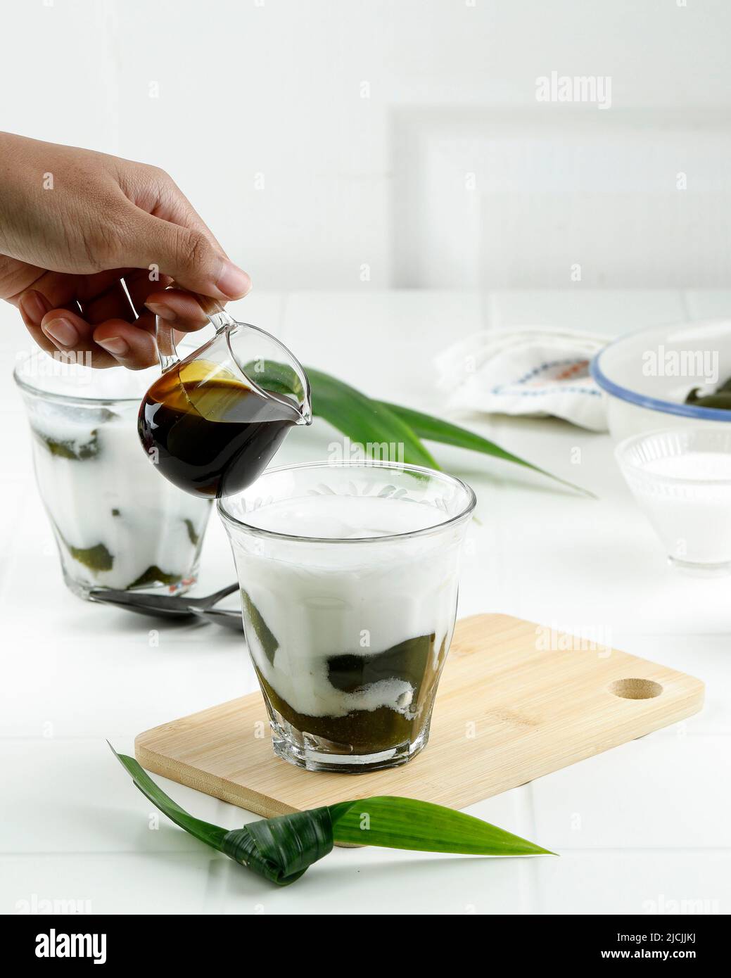 Pour Liquid Palm Sugar to the Glass with Green Grass Jelly Drink or ...