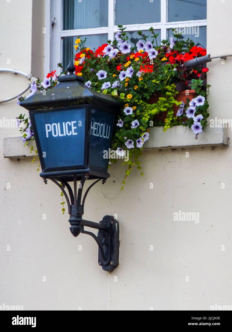 A blue bilingual police lantern outside a police station in Usk ...