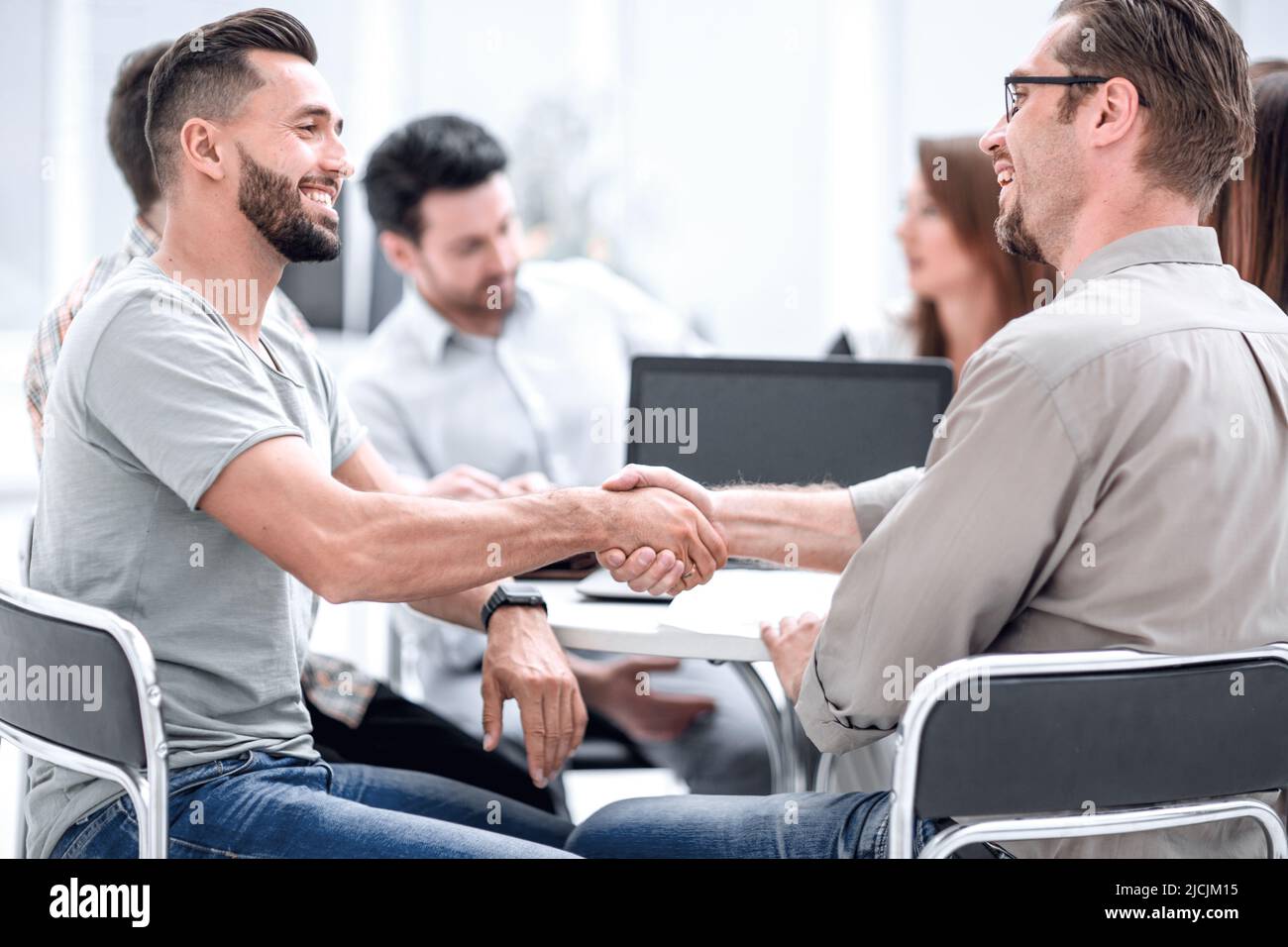 close up.handshake employees at the Desk Stock Photo - Alamy