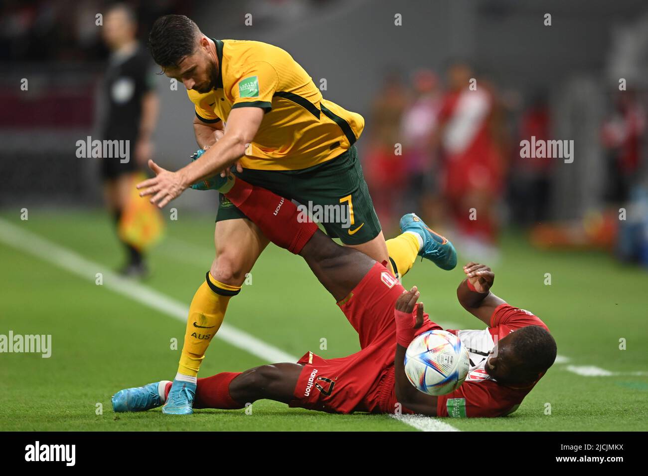 Doha, Qatar. 13th June, 2022. Australia's Mathew Leckie (top) vies with ...