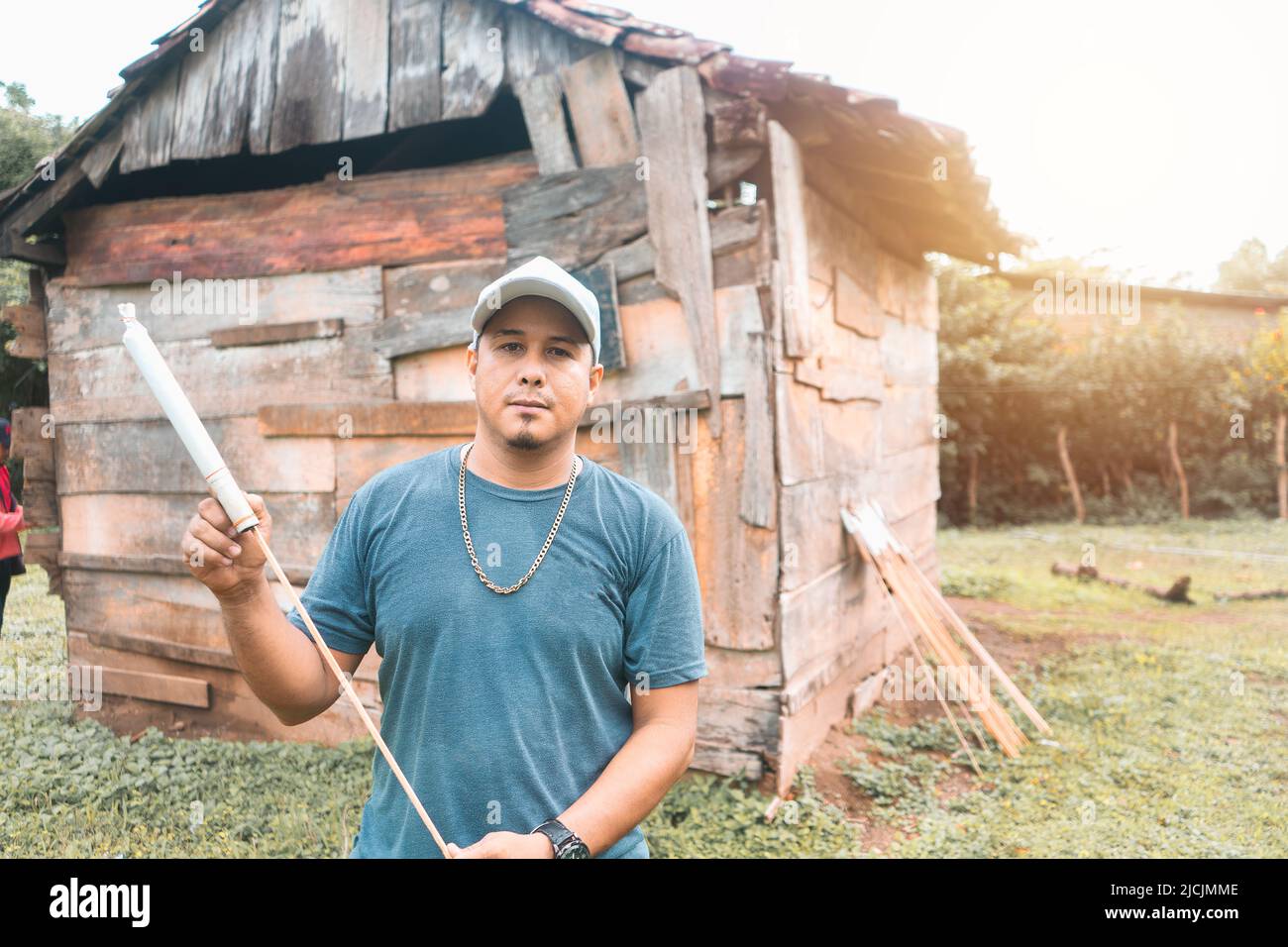 Latino man holding a black powder rocket firework during a celebration ...