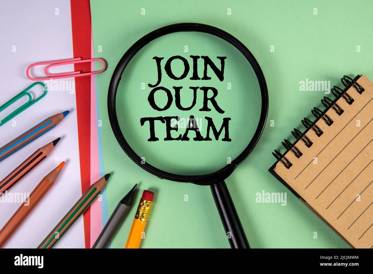 Join Our Team. Pencils, paper and magnifying glass on the office desk ...