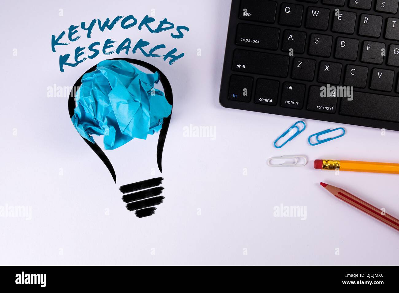 Keywords Research. Abstract light bulb and computer keyboard on a white ...