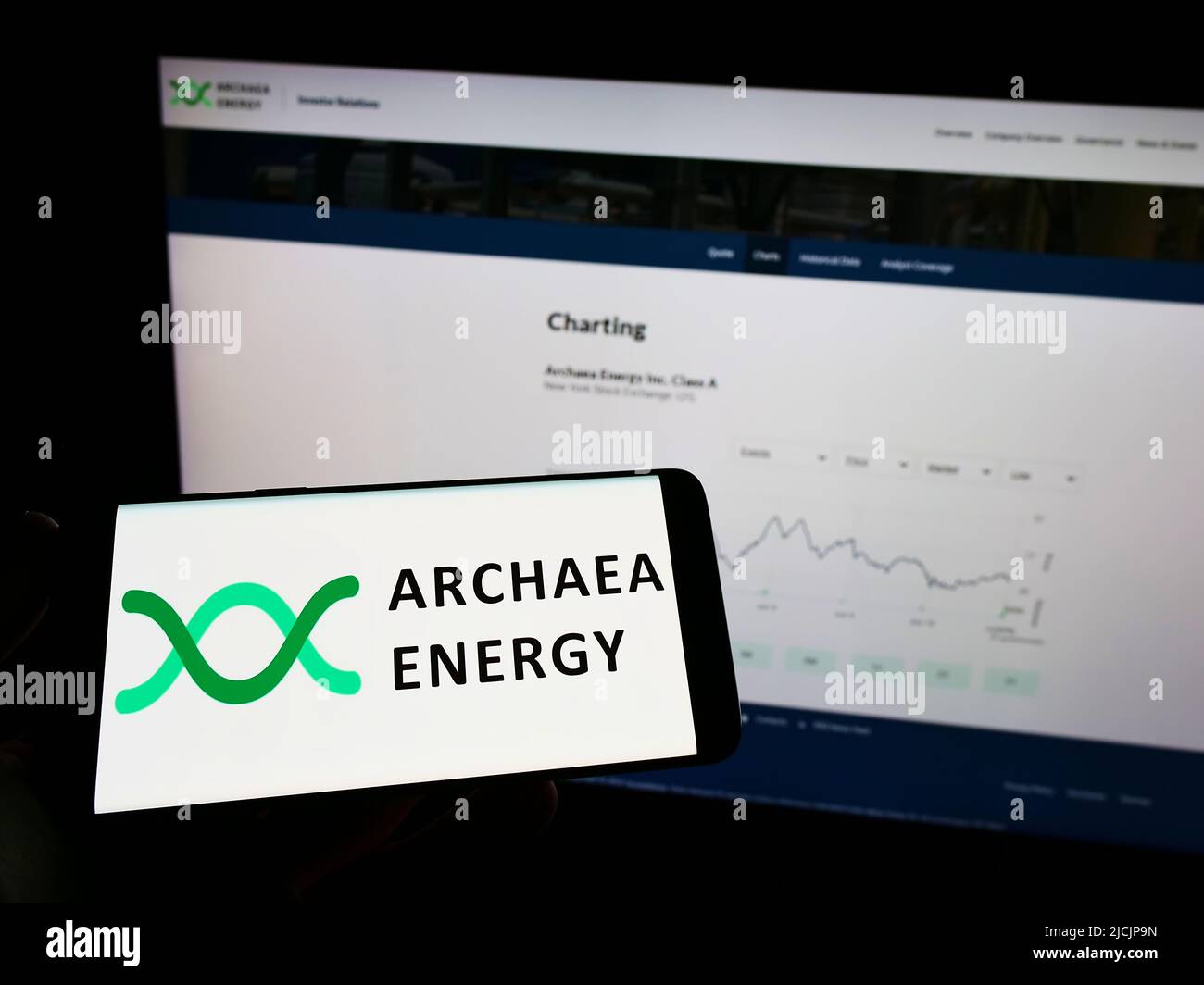 Person holding mobile phone with logo of American gas company Archaea ...