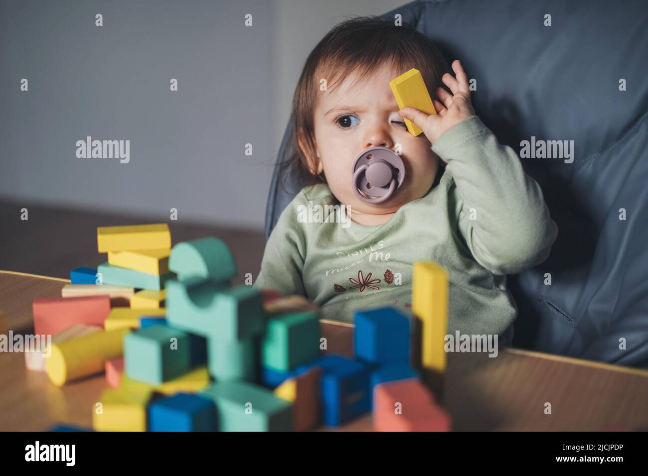 Baby girl building tower of block toys. Baby development. Educational ...