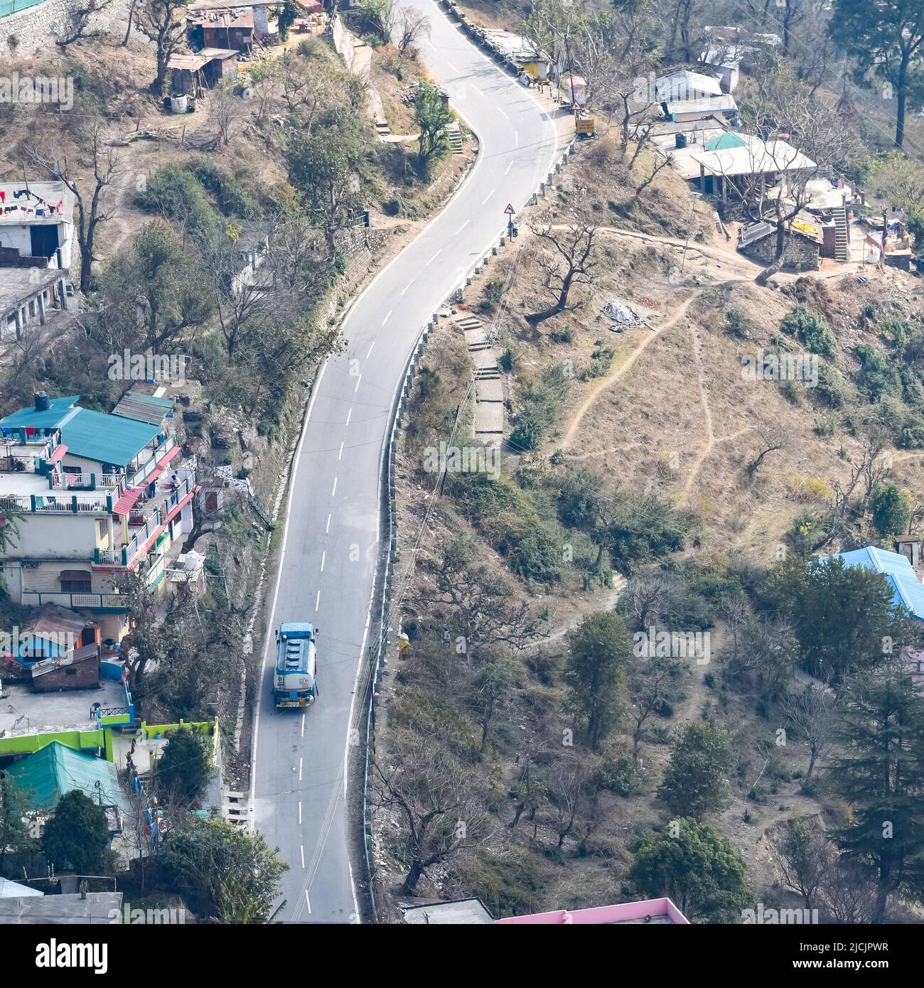 Aerial top view of traffic vehicles driving at mountains roads at ...