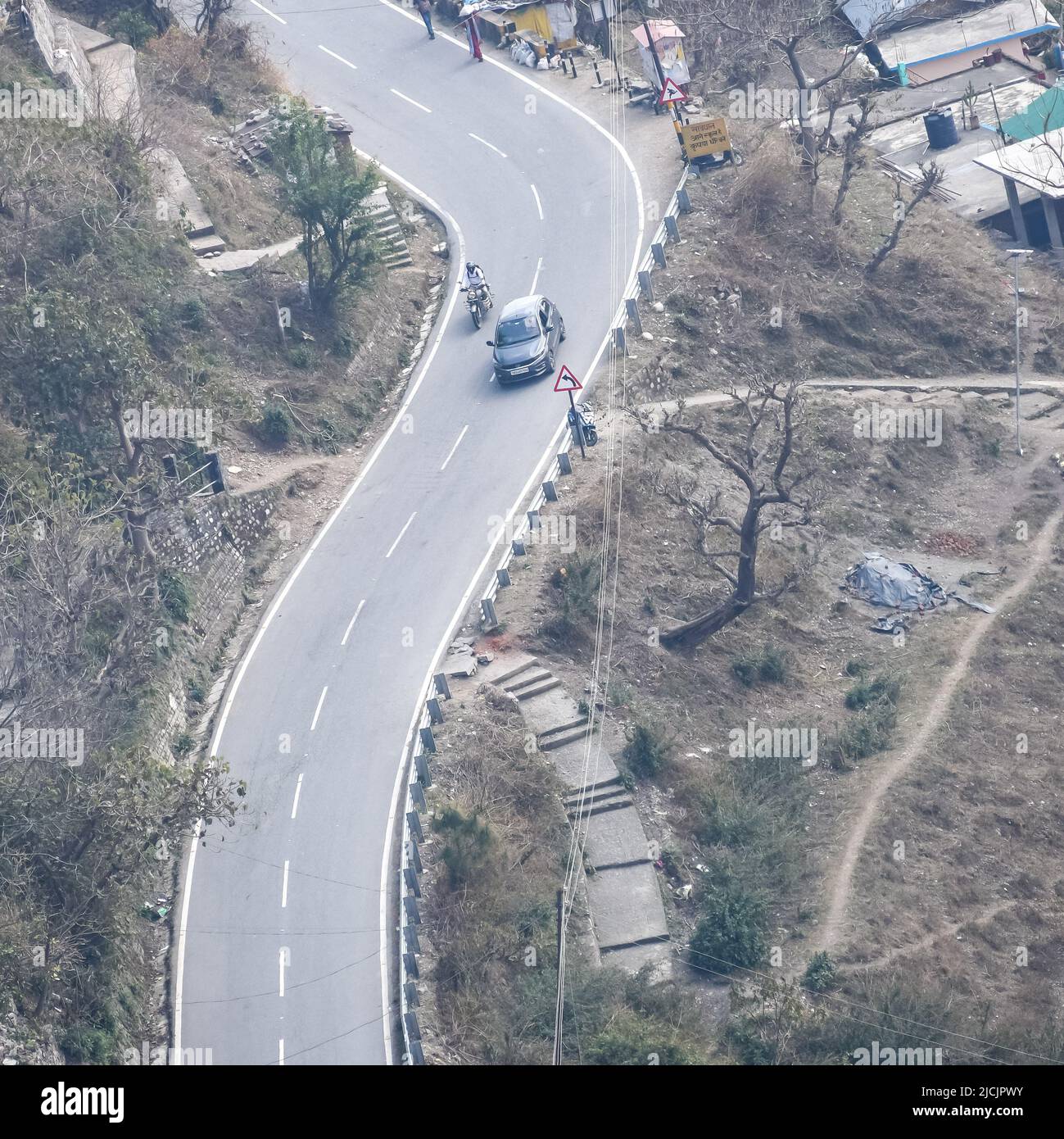 Aerial top view of traffic vehicles driving at mountains roads at ...