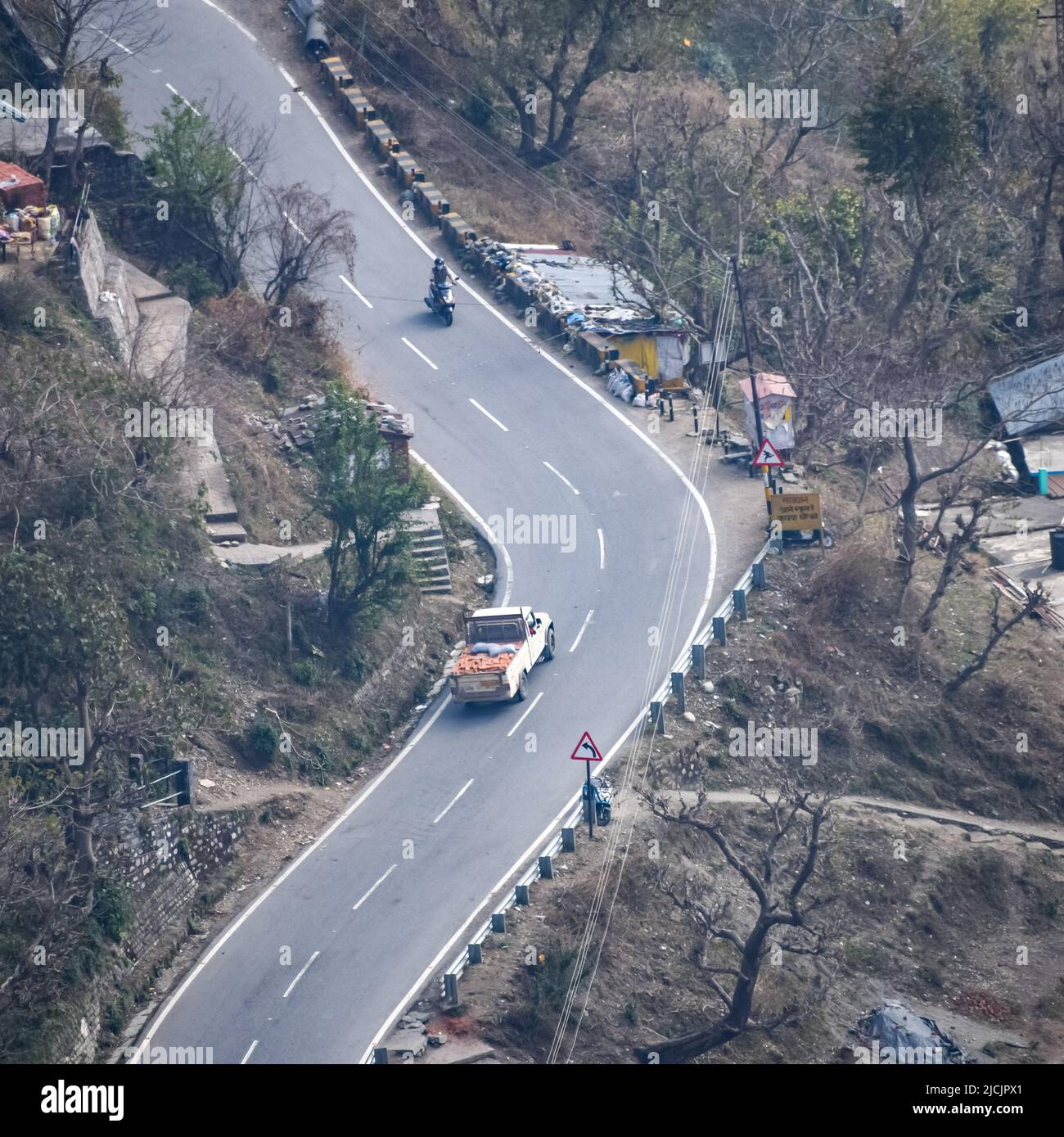 Aerial top view of traffic vehicles driving at mountains roads at ...