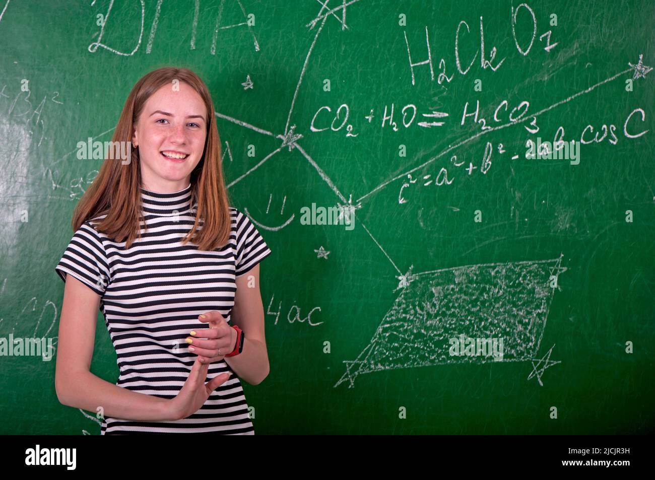 Student girl standing near clean blackboard in the classroom Stock ...