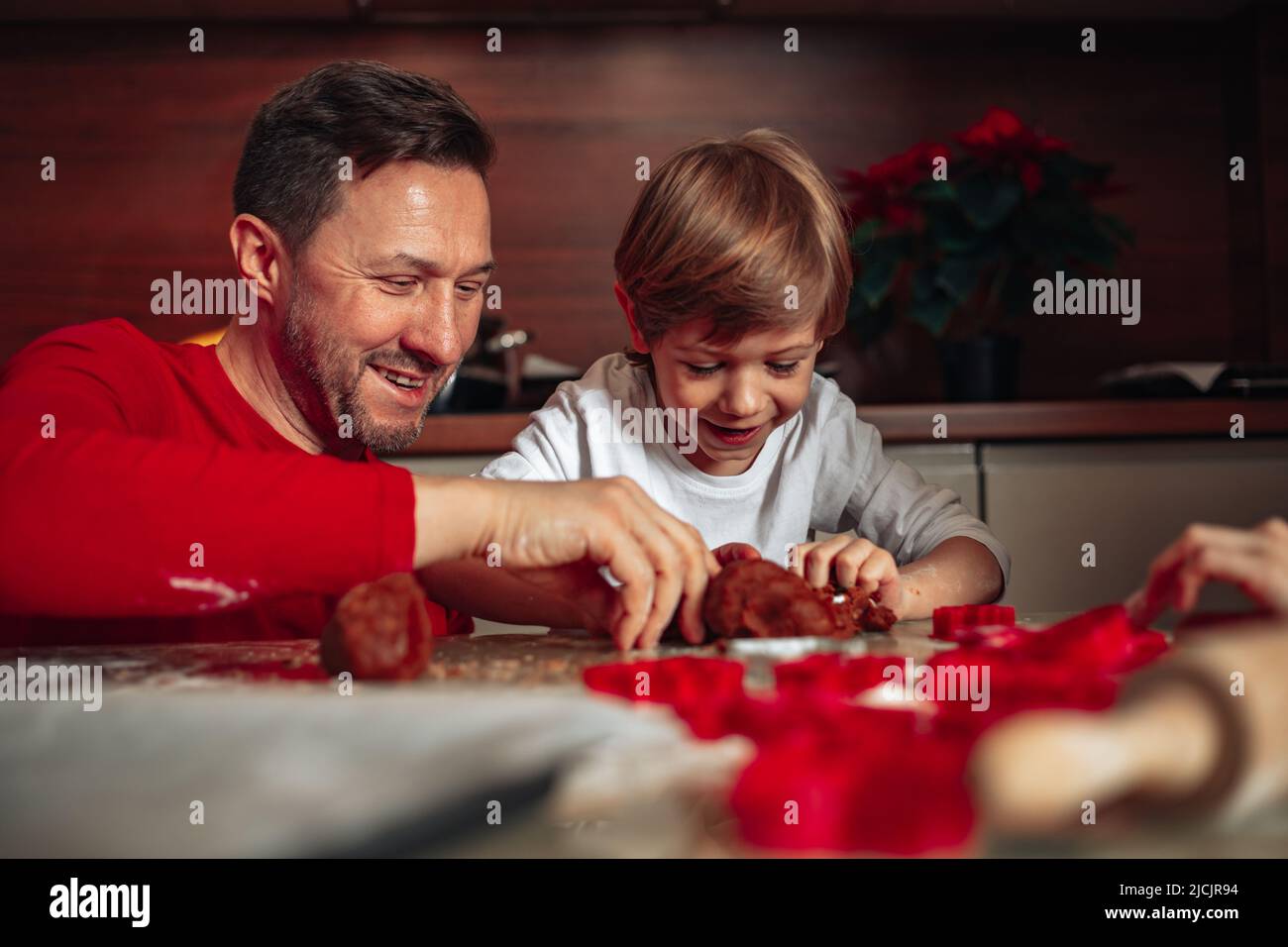 Son and dad. Little boy is happy to spend time with his father. Cookies ...