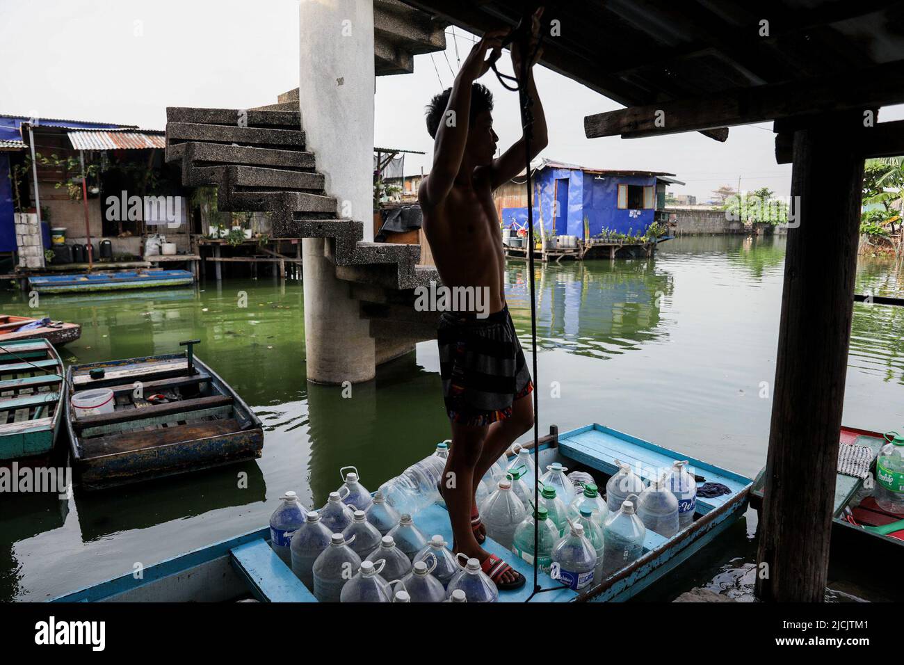June 8, 2022, Manila, Philippines: A man ties his boat to a small dock ...