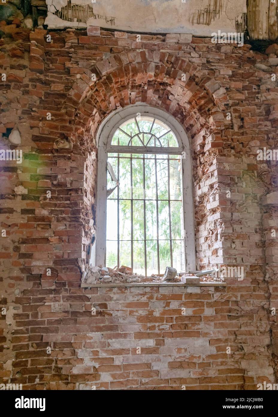 photo with old arched windows in an abandoned church, iron grilles in ...
