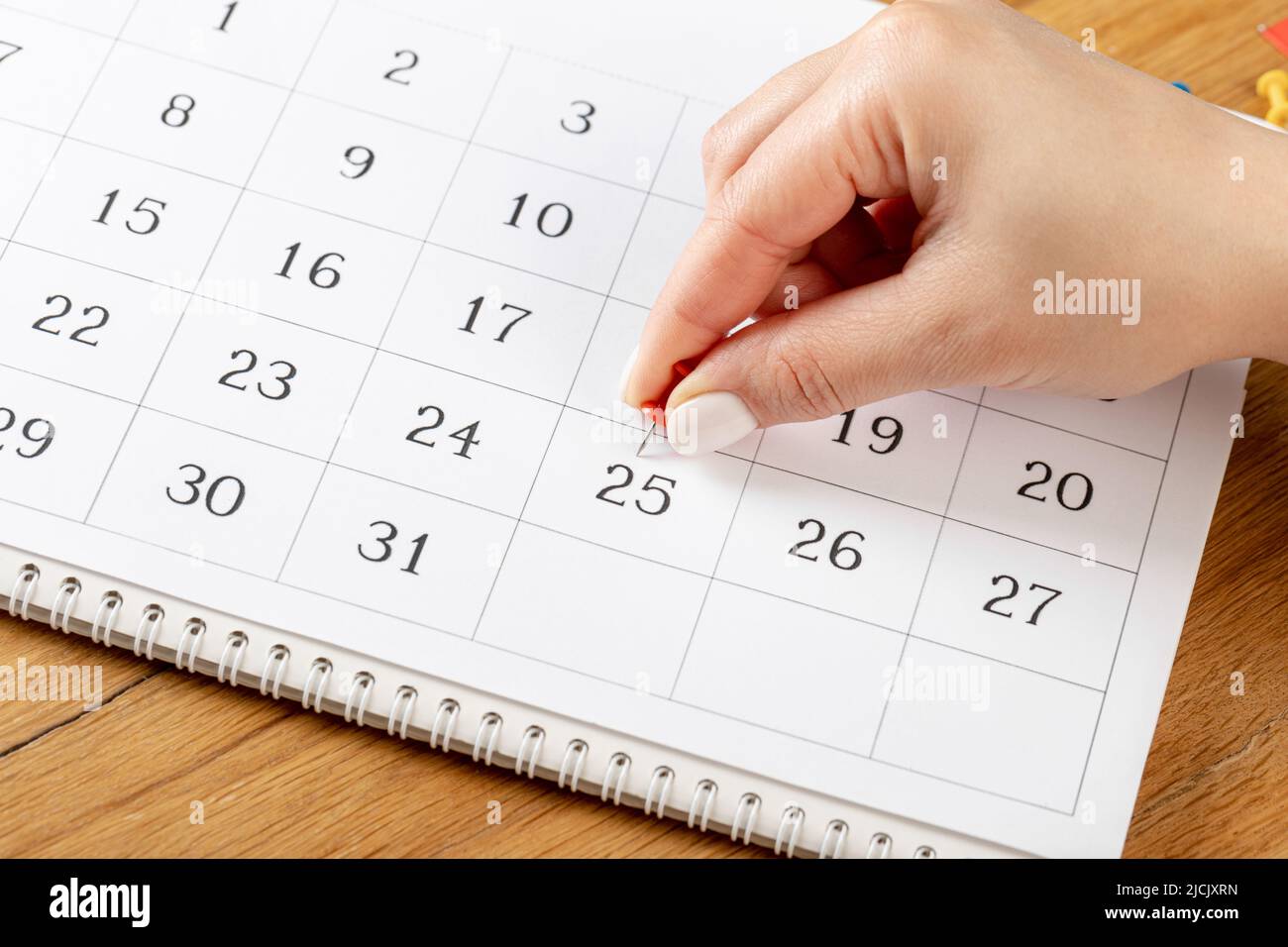 red Hand pin stuck on the day of the month in the calendar, business ...