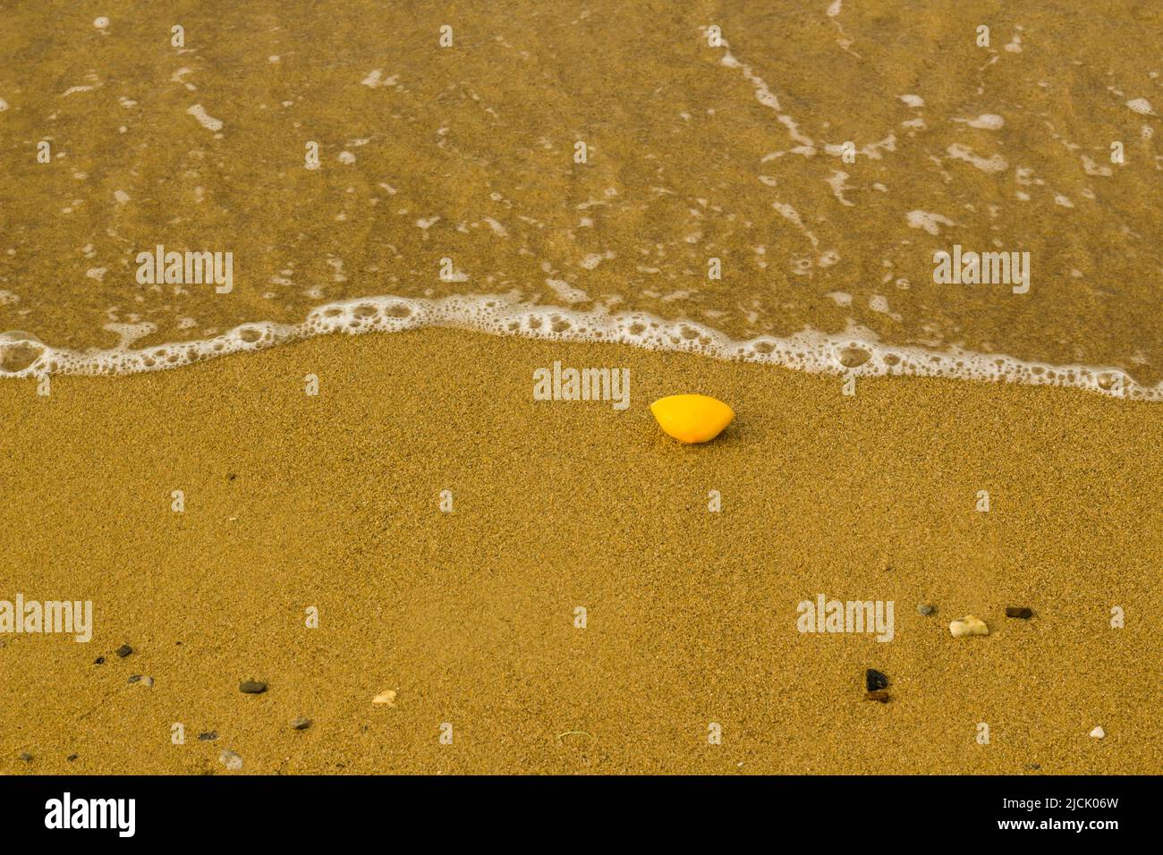 Beach half covered with sea water and half lemon peel, top view Stock ...