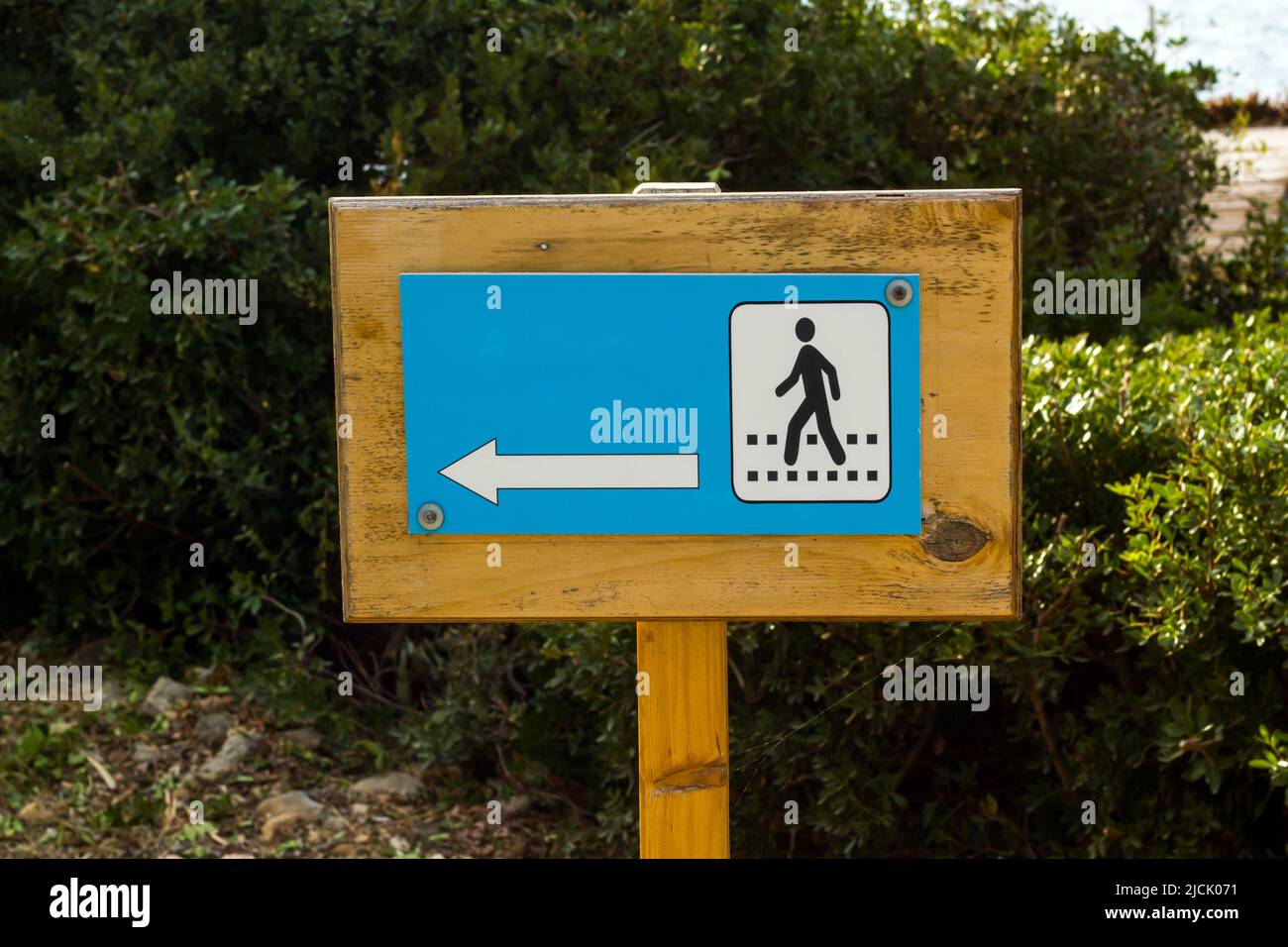 Warning arrow on the wooden sign indicating the walking path Stock ...
