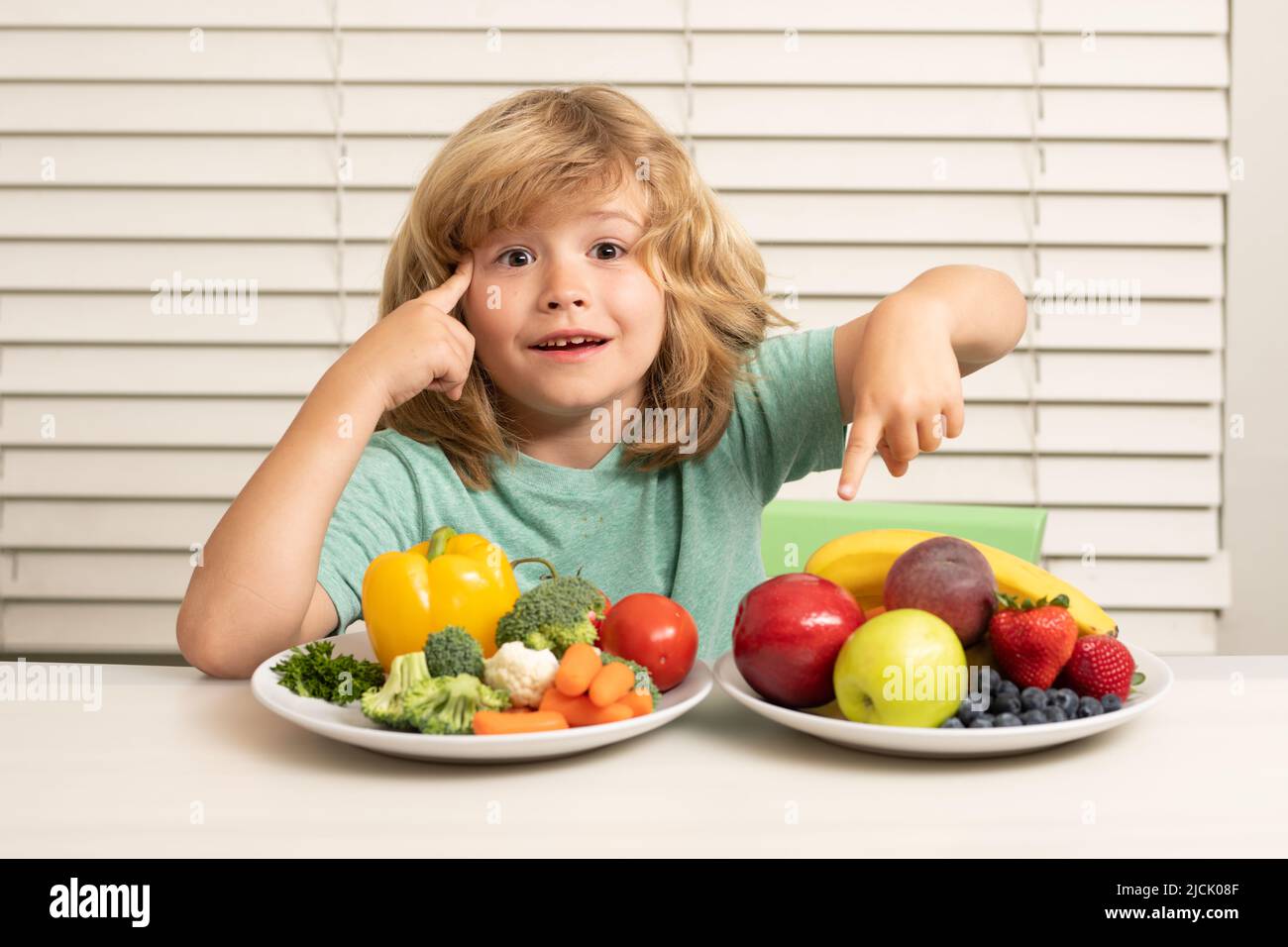 Fruits and vegetables. Kid boy eating healthy food vegetables ...