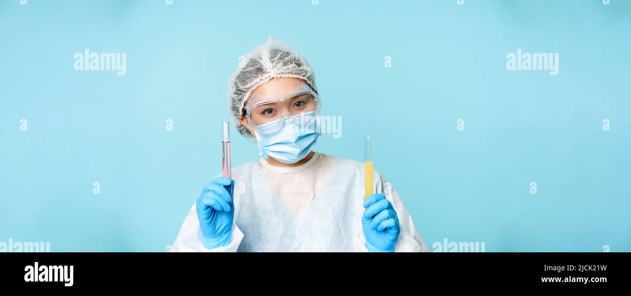 Laboratory and medical tests concept. Smiling asian female doctor, lab ...