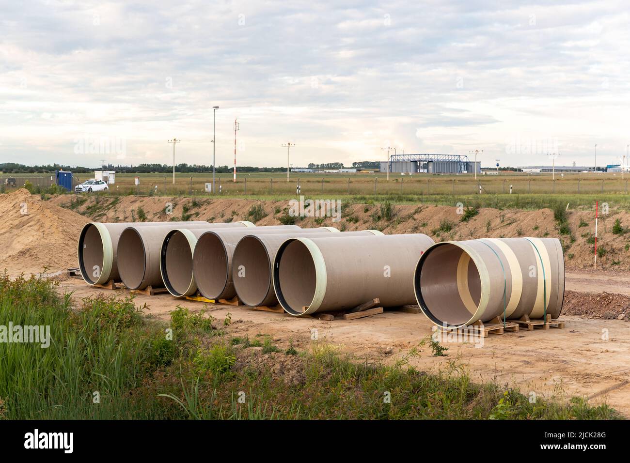 Stack of big frp composite fiberglass plastic sewage pipes at warehouse ...