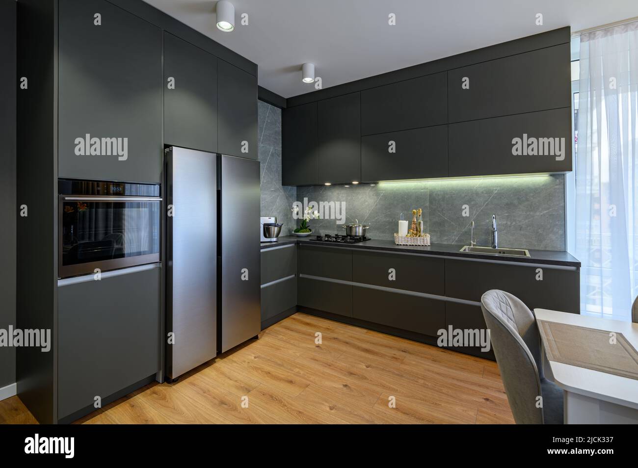 Modern large luxury dark gray kitchen Stock Photo - Alamy
