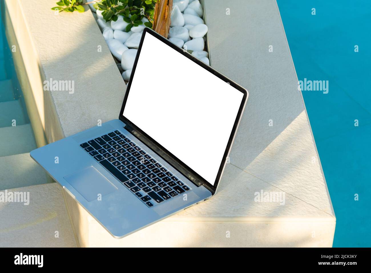 laptop with blank screen near the pool Stock Photo - Alamy