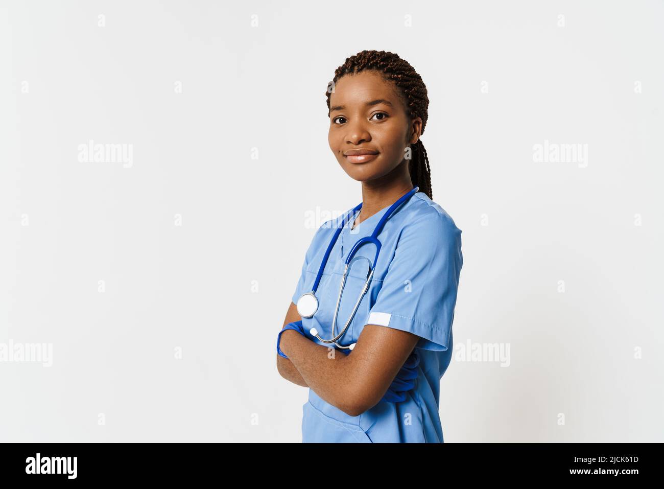 Black doctor wearing uniform smiling while posing with stethoscope ...