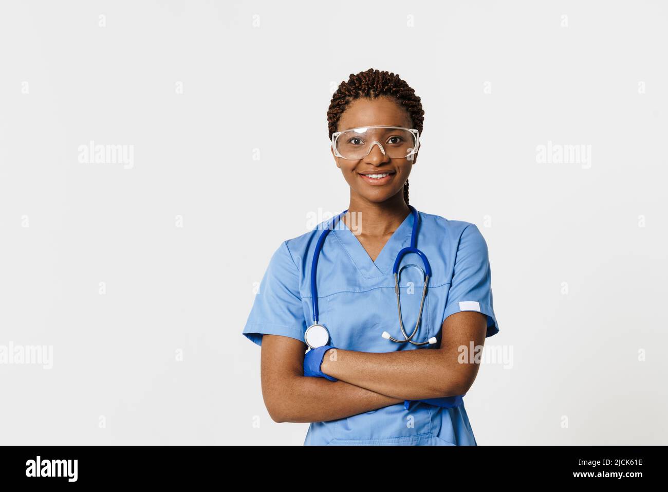 Black doctor wearing uniform smiling while posing with stethoscope ...