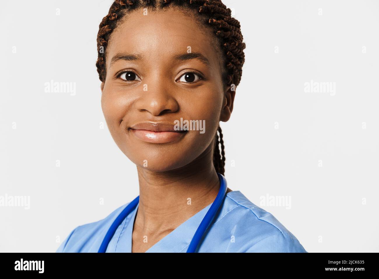 Black doctor wearing uniform smiling while posing with stethoscope ...