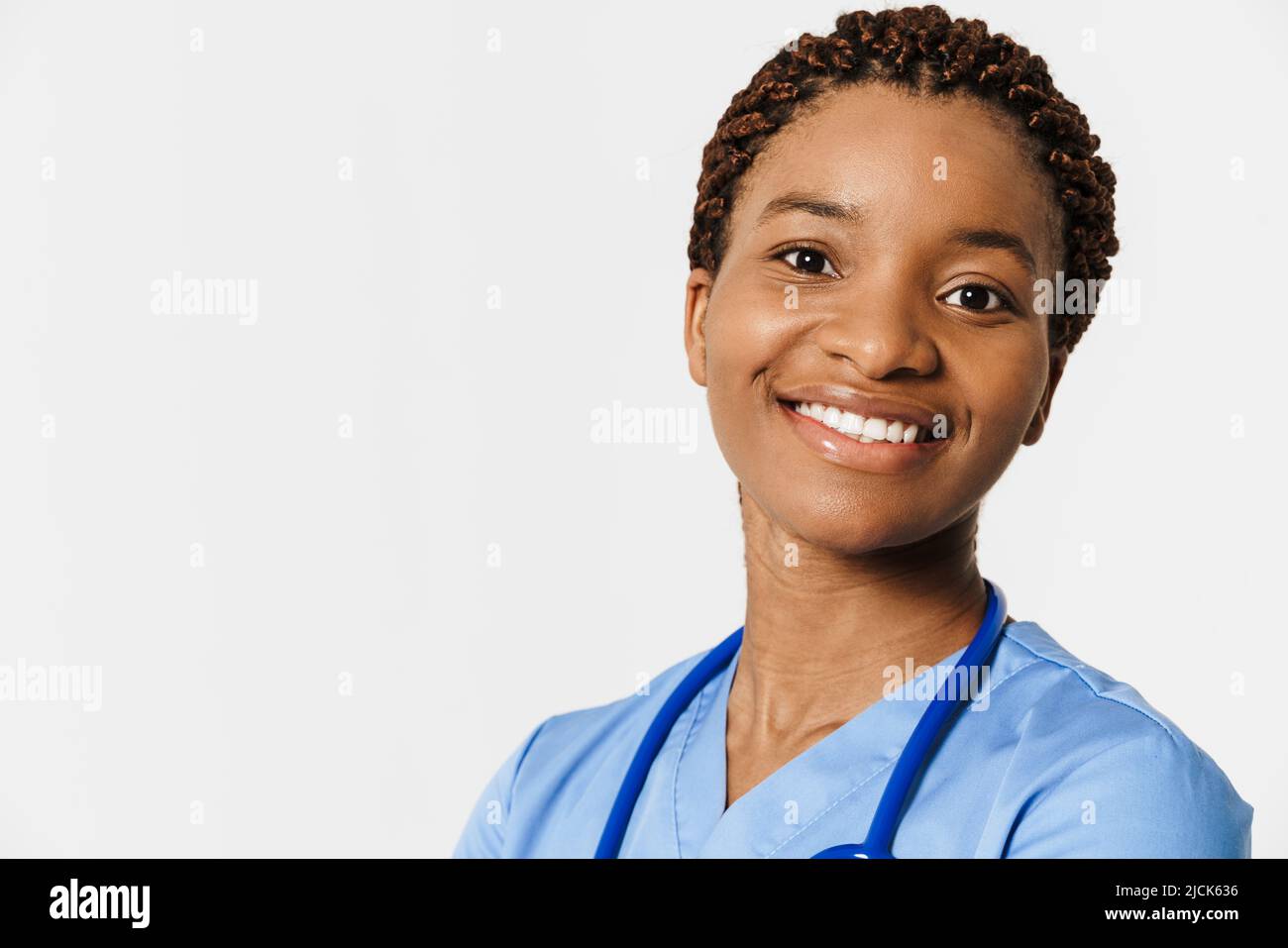Black doctor wearing uniform smiling while posing with stethoscope ...