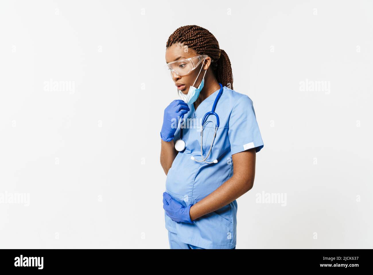 Black pregnant doctor wearing face mask posing with stethoscope ...