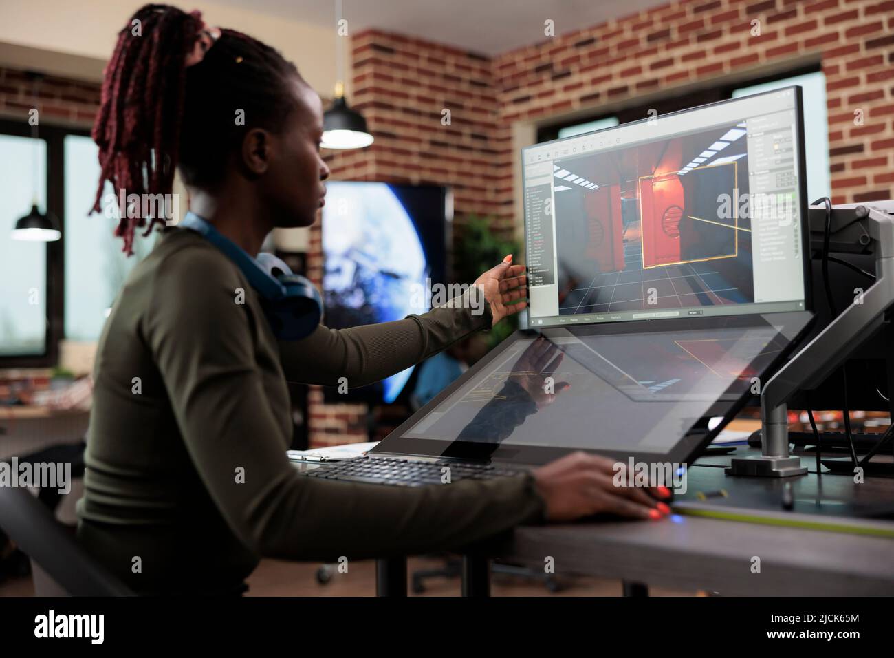 Creative game creator works with graphics for new level design while ...