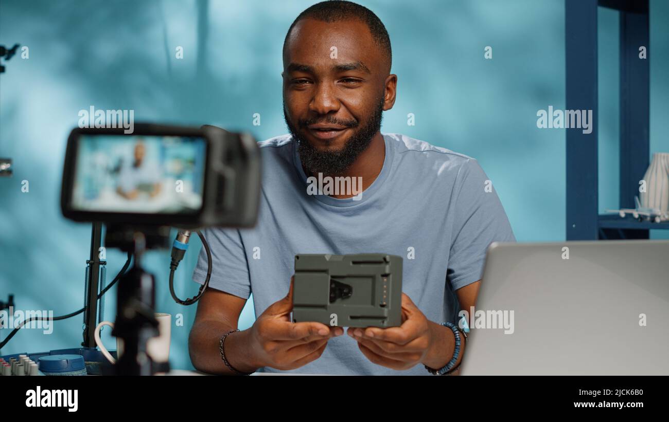 Influencer reviewing v mount power battery on camera for recommendation ...