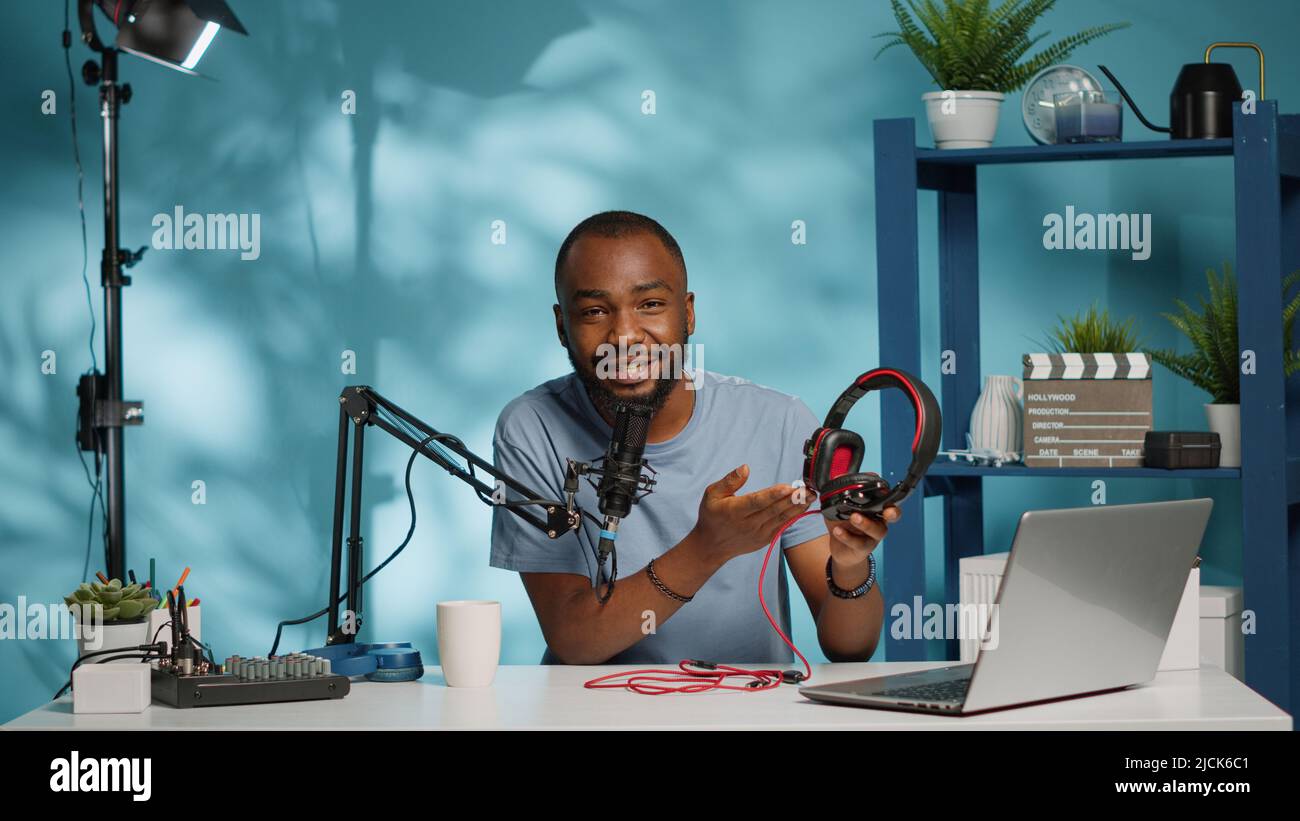 POV of influencer reviewing headphones on camera for vlog channel ...