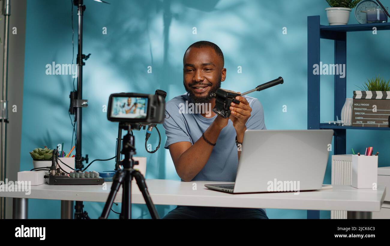 Vlogger holding tripod head for recommendation on camera. Social media ...