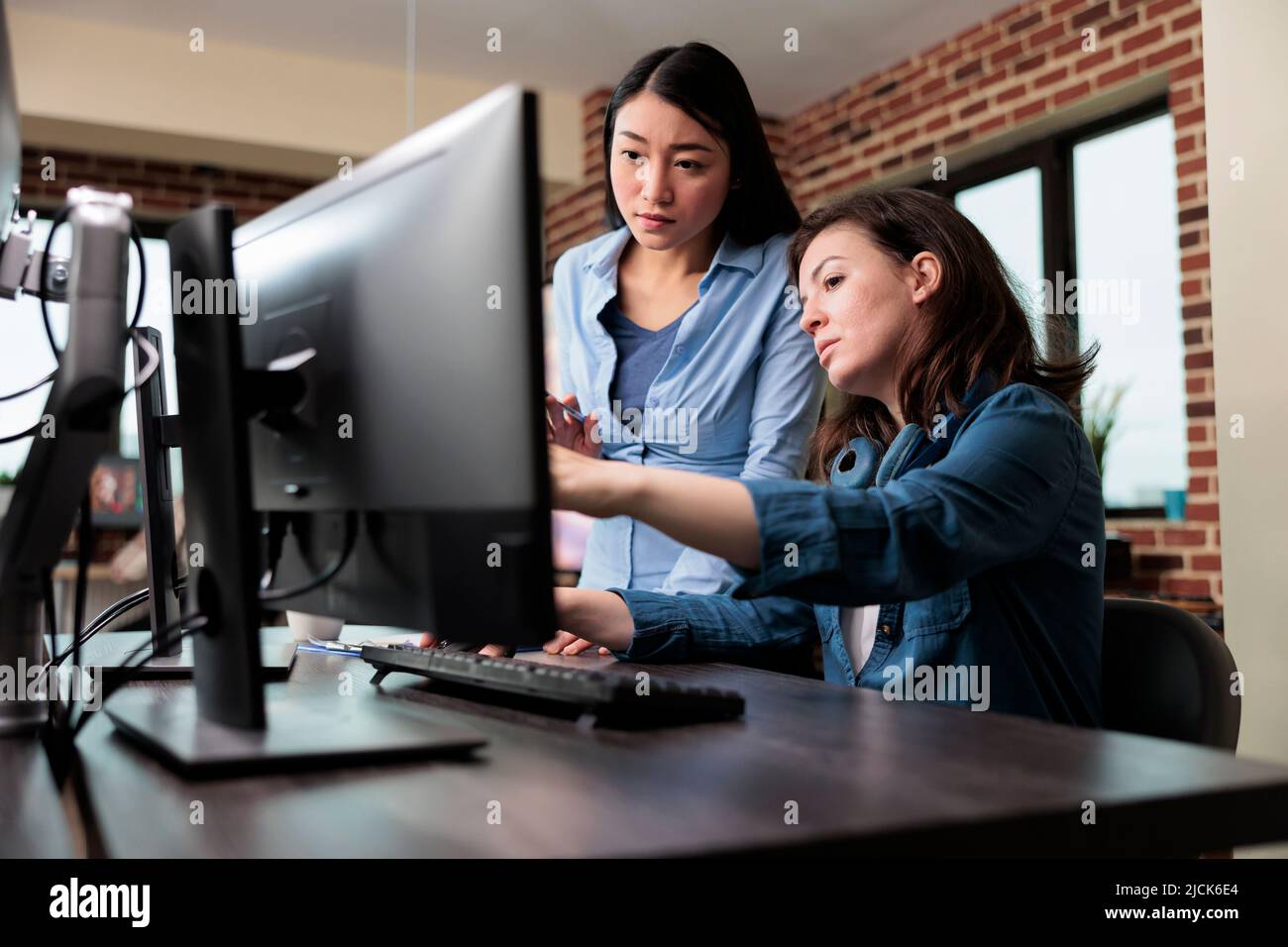 Professional office workers pointing out wrong blueprint of project ...