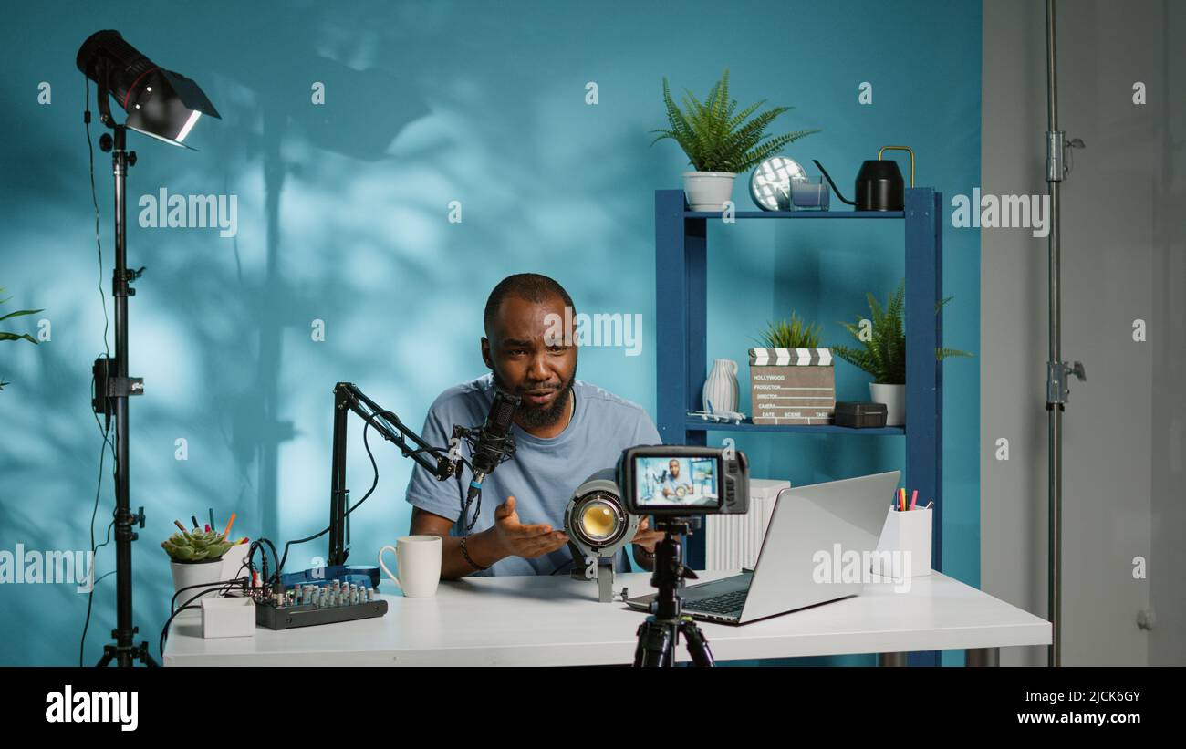 Black influencer talking about studio light for vlog review on camera ...