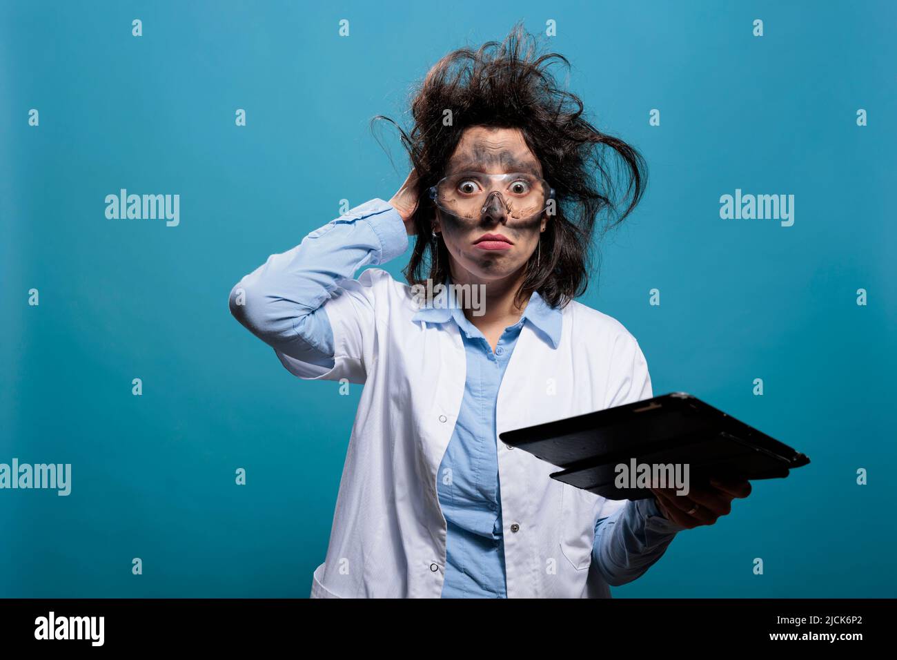 Insane looking biochemistry specialist with touchscreen device looking ...