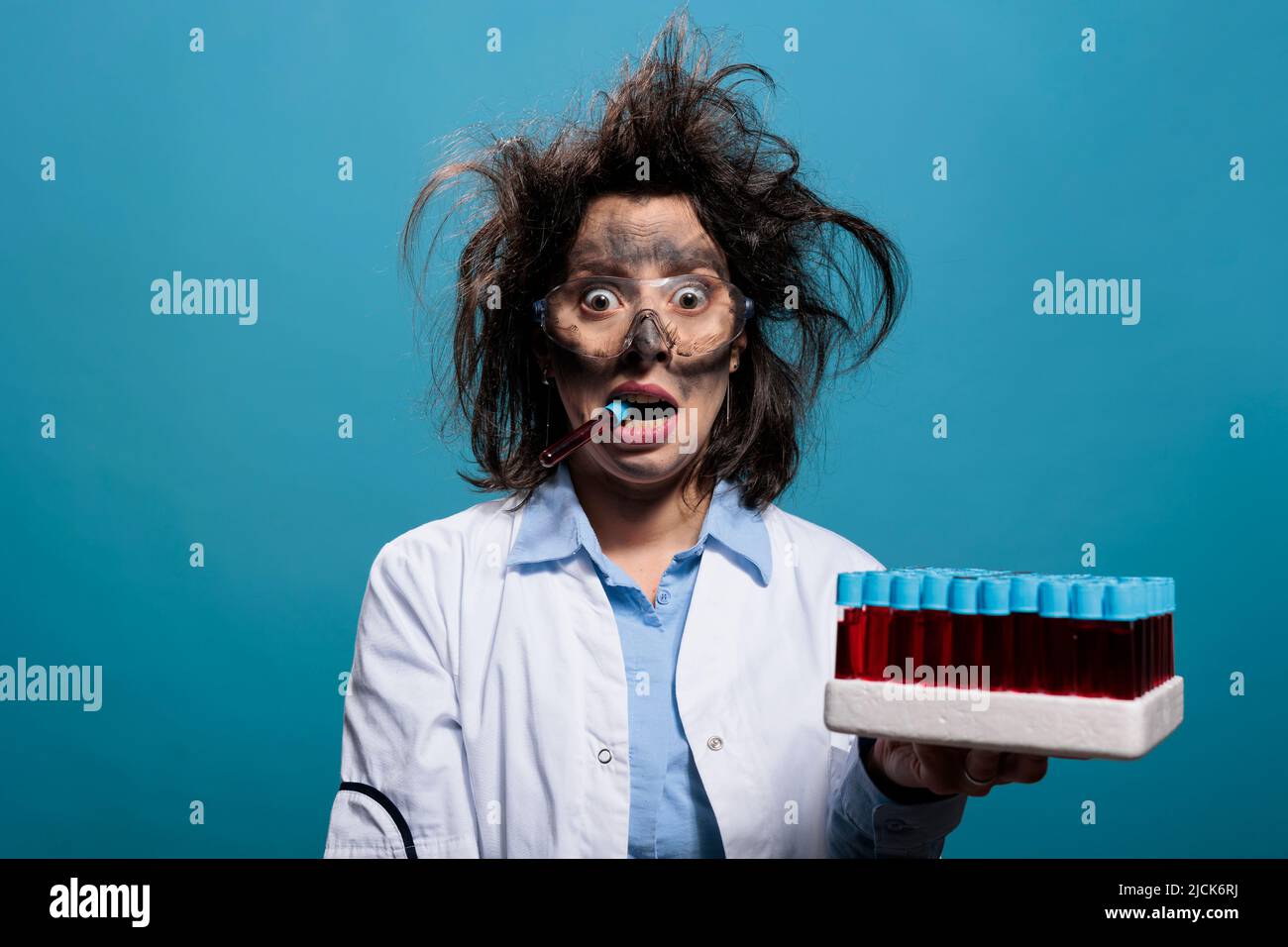 Shocked mad scientist with messy hair and dirty face having glass test ...