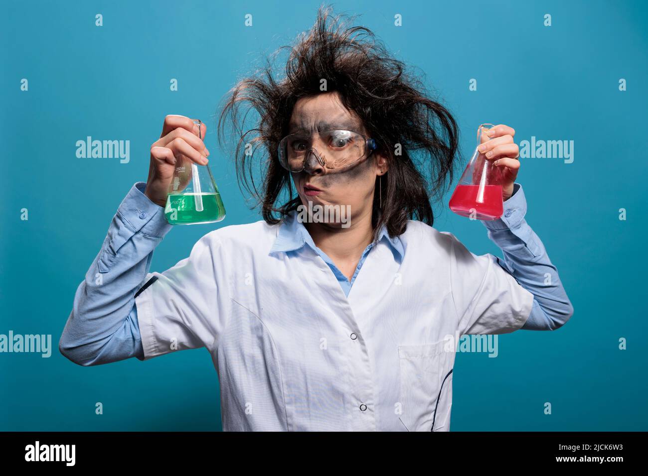Mad chemist having beakers filled with toxic liquid substances while on ...