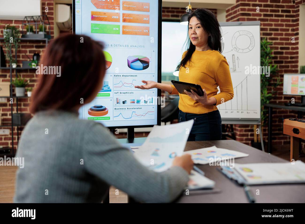 Executive manager showing company graphs using vertical monitor ...