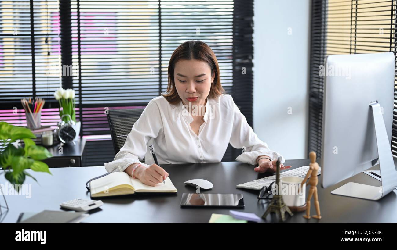 Focused asian woman business entrepreneur sitting front of computer and ...