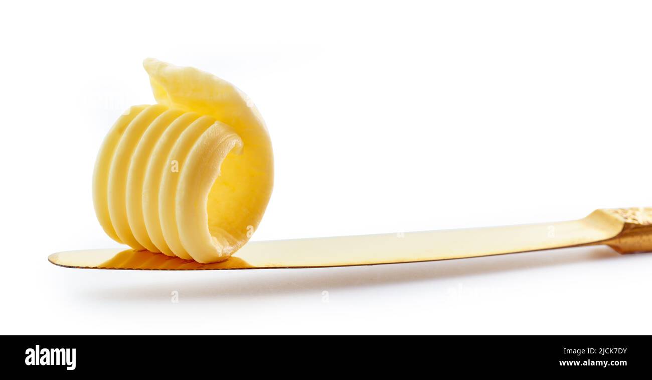 curl of fresh butter on a gold knife isolated on white background Stock ...