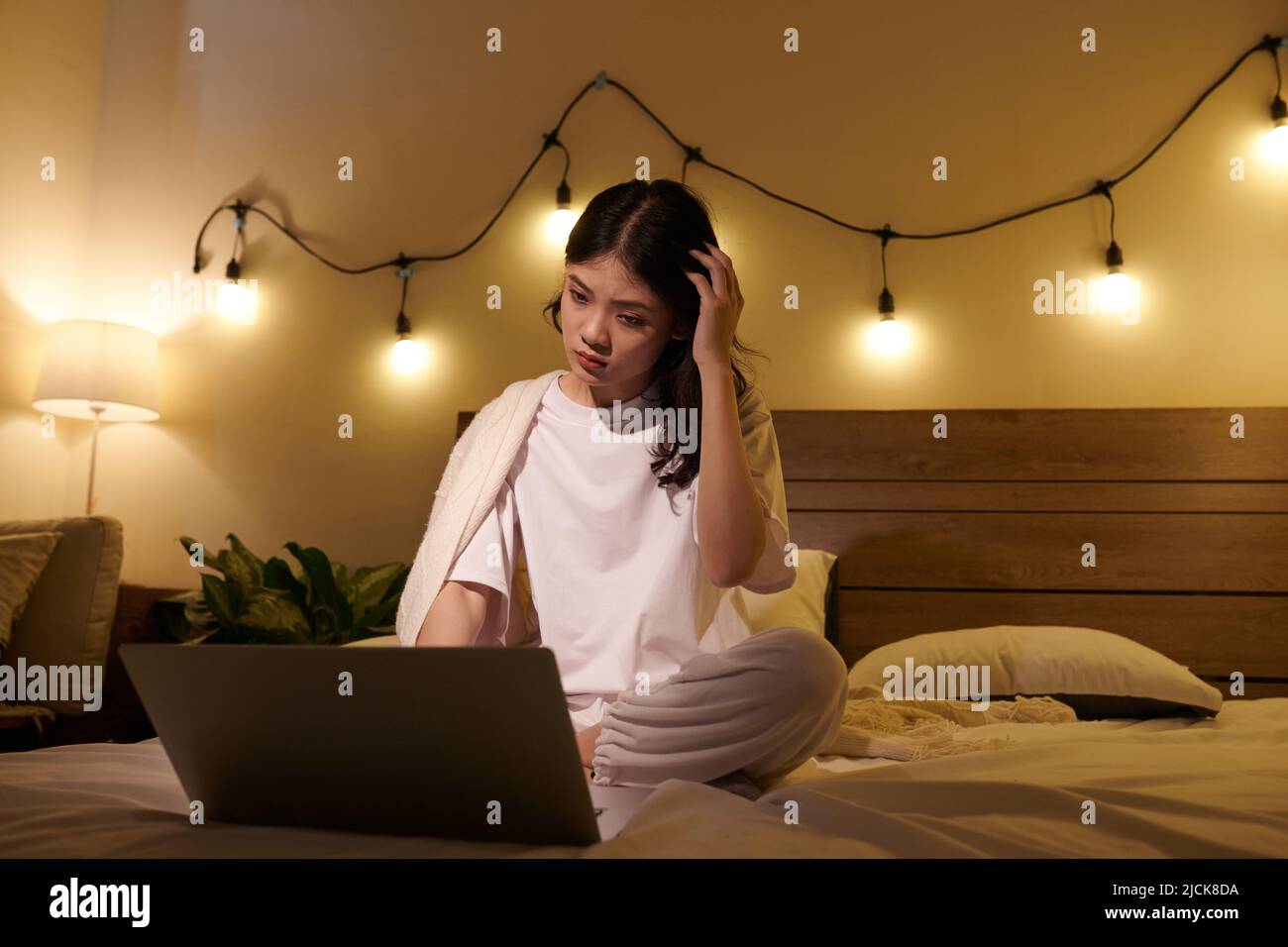 Confused teenage girl trying to find mistake in programming code on ...