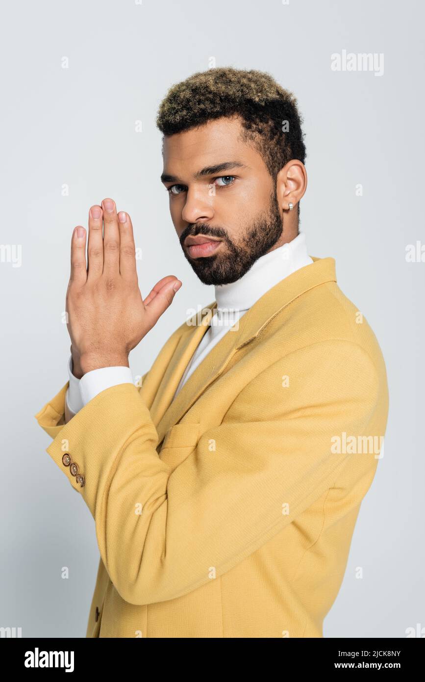 Stylish man praying in studio hi-res stock photography and images - Alamy